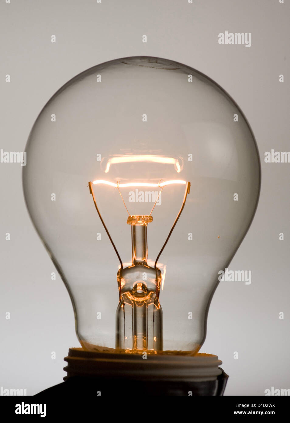 The picture shows a glowing filament in a conventional light bulb in ...