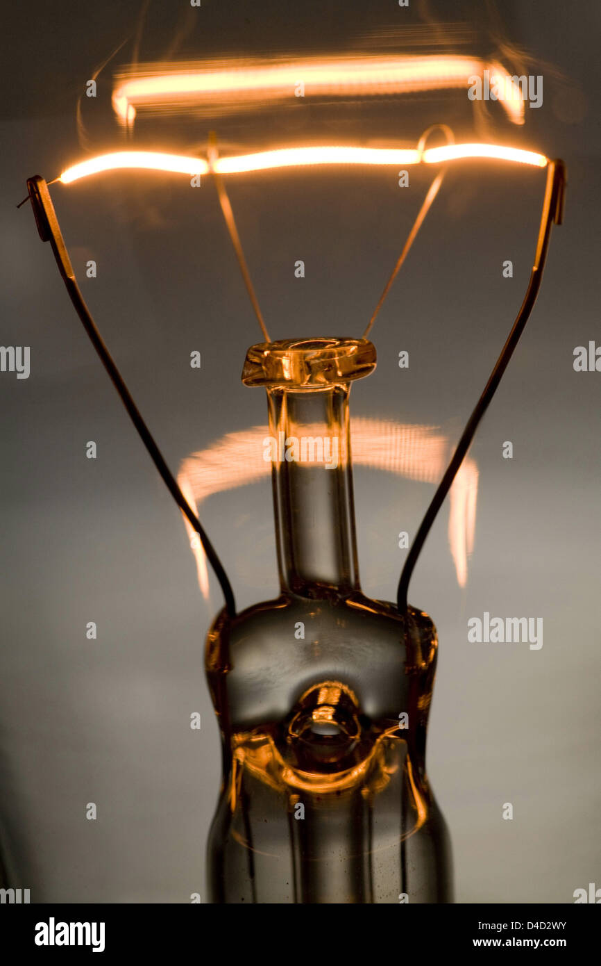 The picture shows a glowing filament in a conventional light bulb in ...