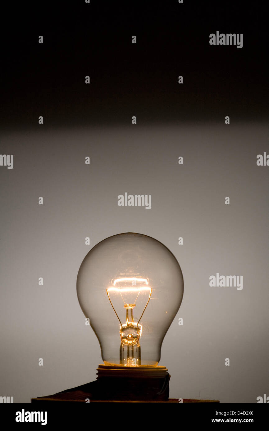 The picture shows a glowing filament in a conventional light bulb in ...