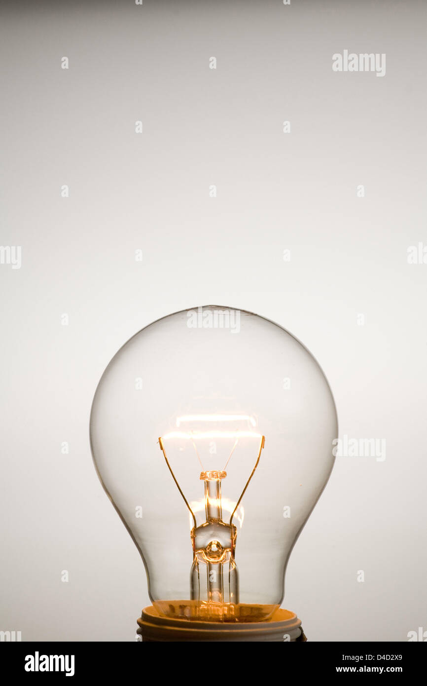 The picture shows a glowing filament in a conventional light bulb in ...