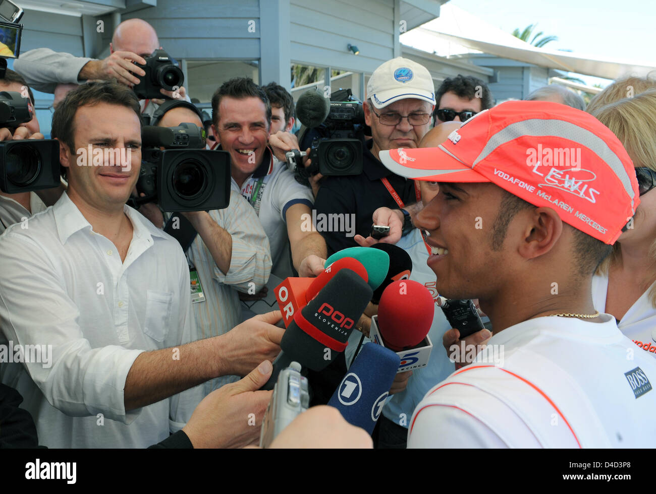 British Formula One driver Lewis Hamilton of McLaren Mercedes (R) gives ...