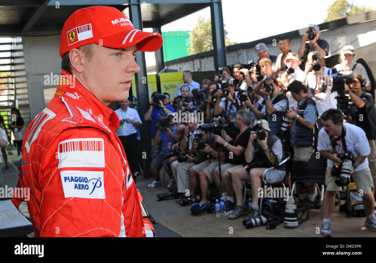 Finnish Formula One driver Kimi Raikkonen (L) of Scuderia Ferrari poses ...