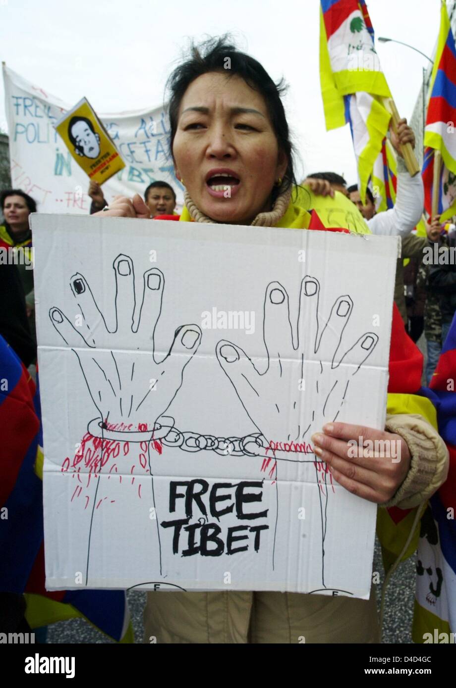An activist holds a poster as a protest against the Chinese Tibet ...