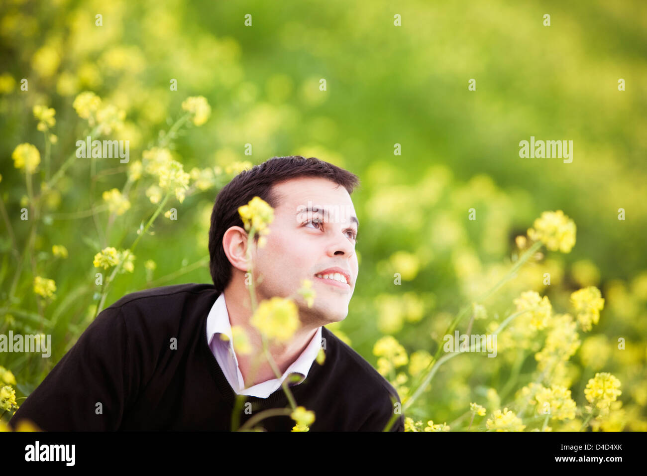 Young handsome guy on field showing hopeful facial expression Stock ...