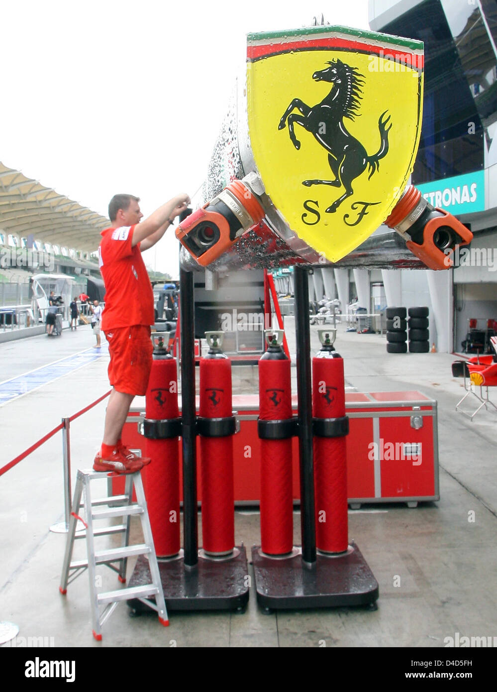 Mechanics of Ferrari work in the pitlane at the Sepang circuit near ...