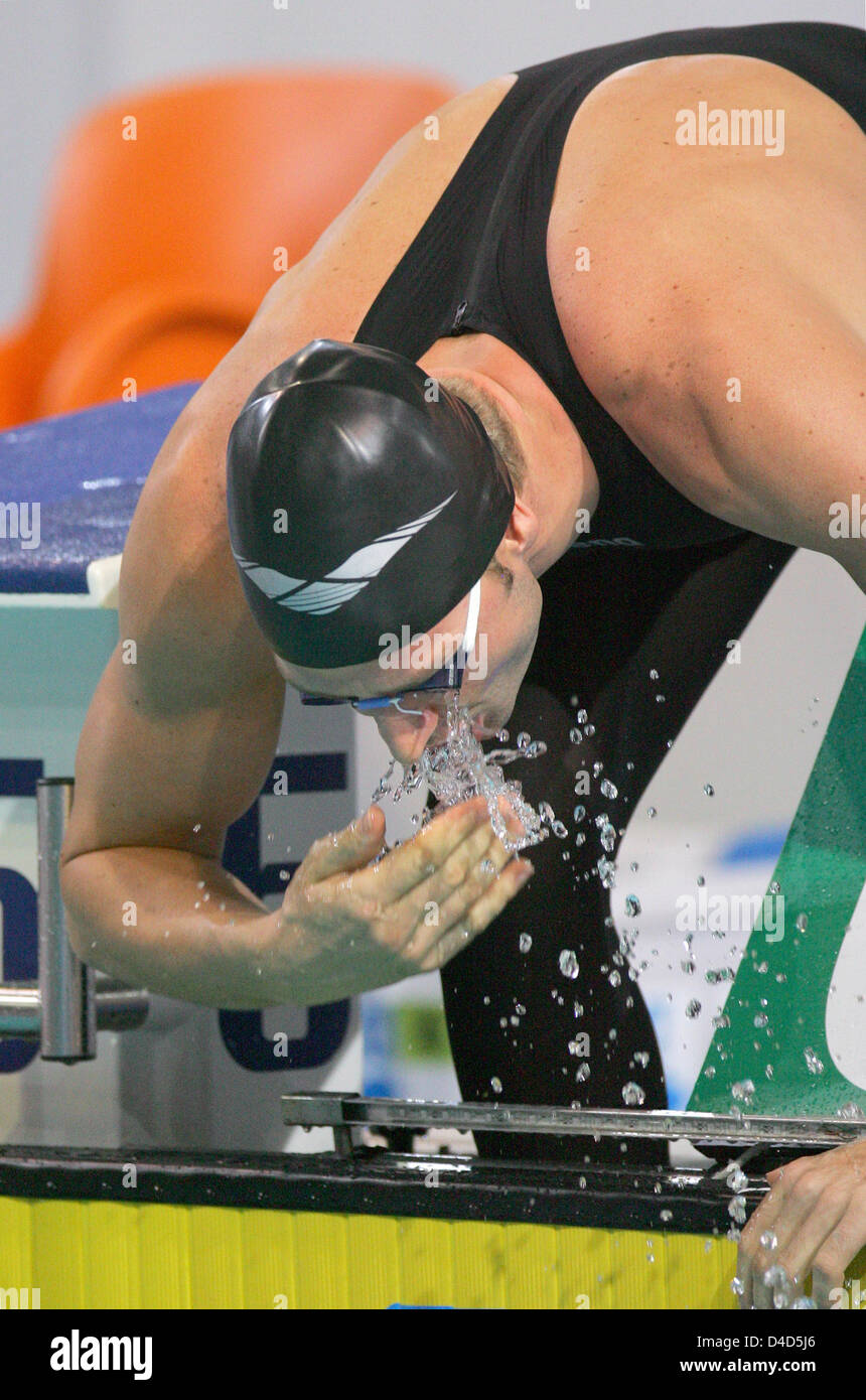 Italian swimmer Massimiliano Rosolino sprays water into his face prior ...