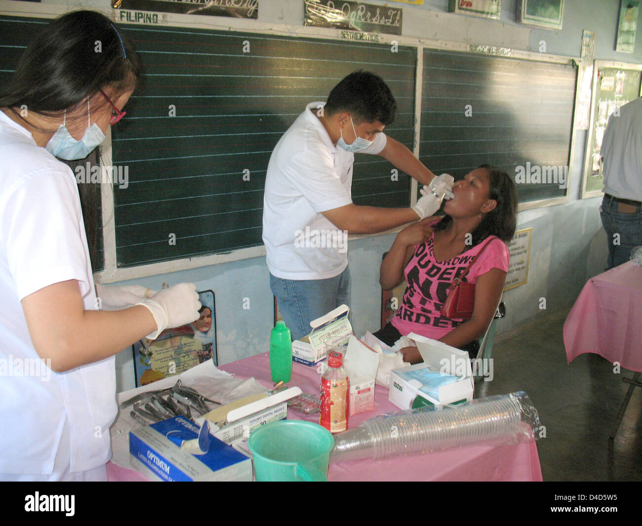 A local resident is treated for free by a denists who arrived with ...