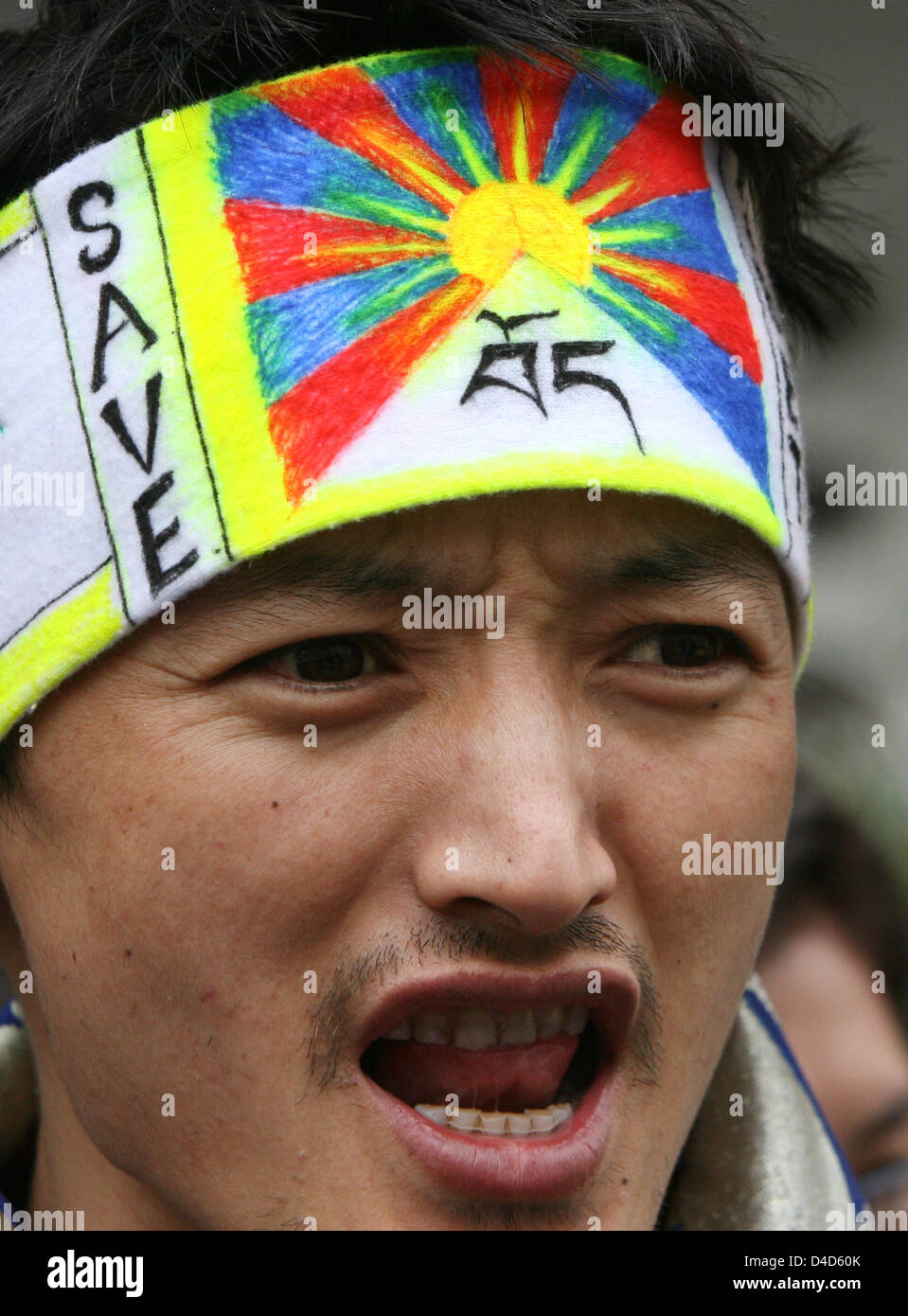 A protestor wears a bandana reding 'Save Tibet' during a protest rally ...
