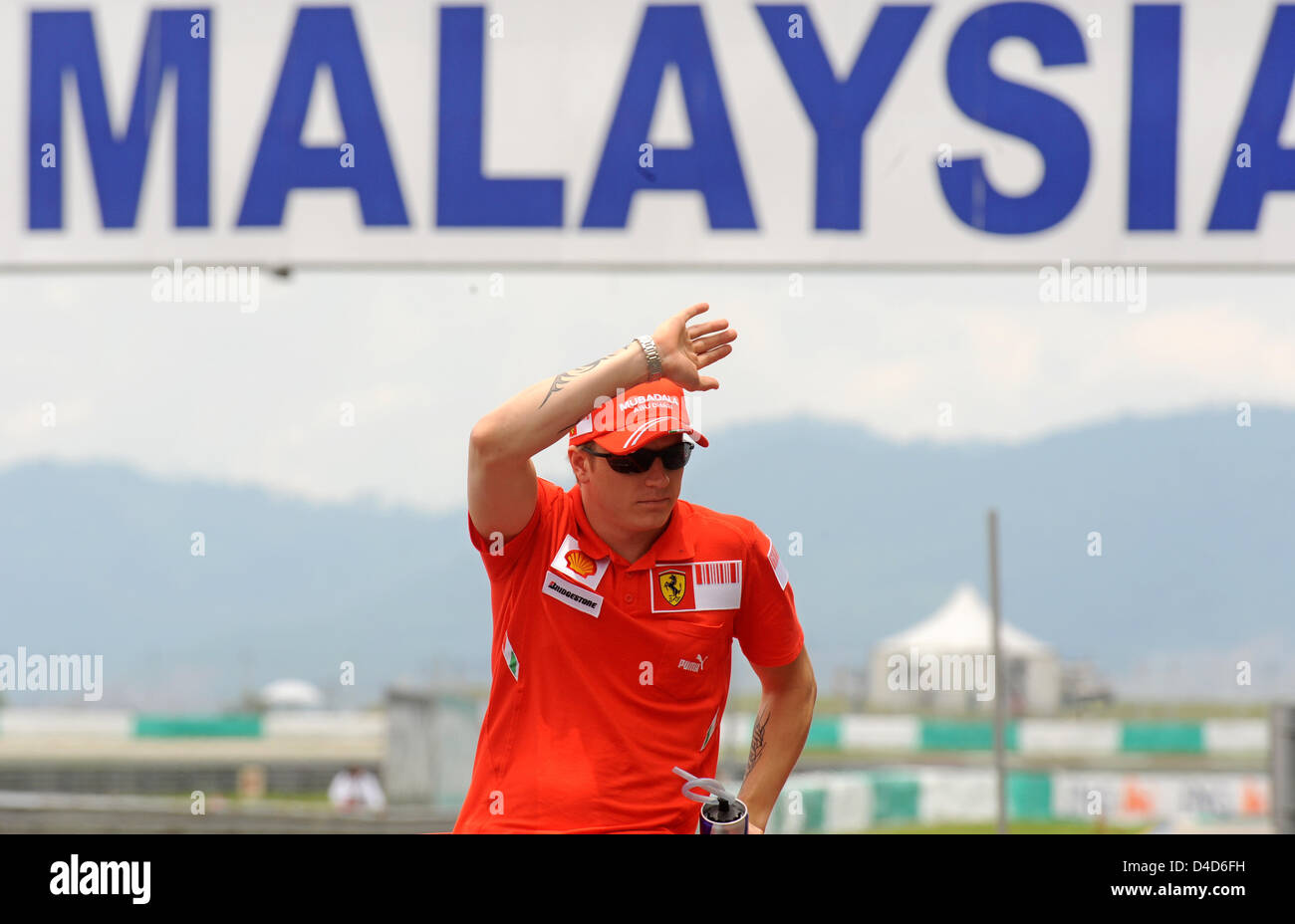 Finnish Formula One driver Kimi Raikkonen of Scuderia Ferrari waves to ...