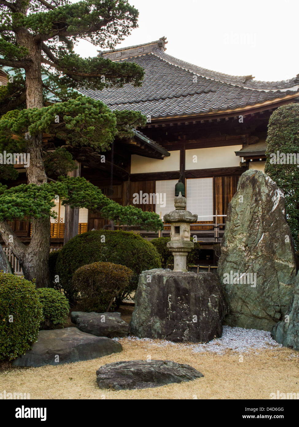 A traditional garden in a Japanese temple featuring natural boulders, a ...