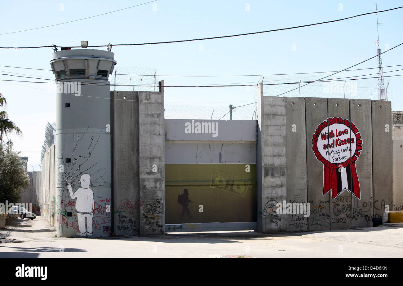 The picturre shows a watchtower, a gate and graffiti on the Israeli ...