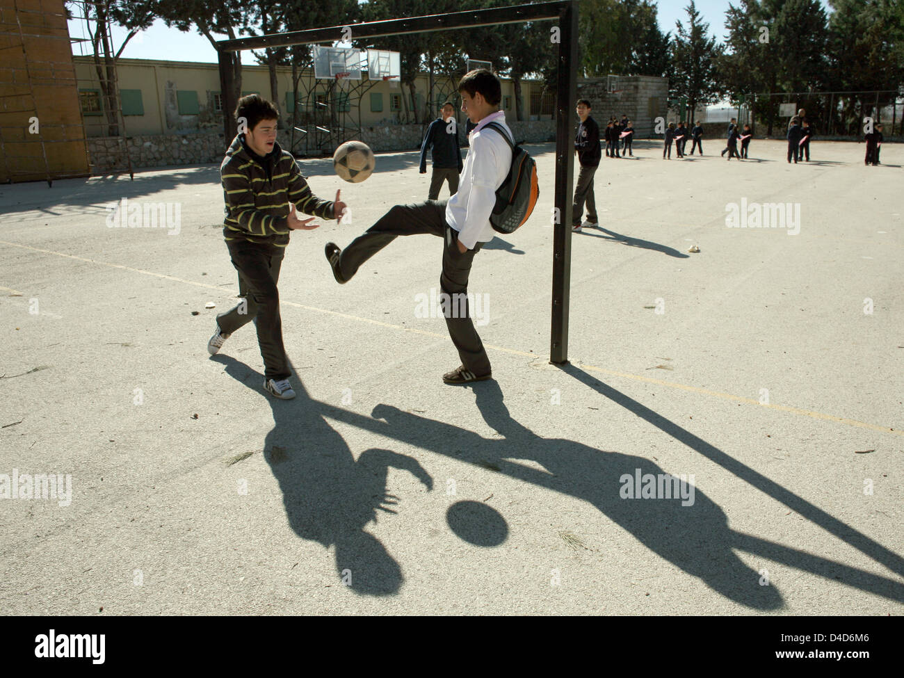 Pupils play soccer on a sports field of the Talitha Kumi school centre ...