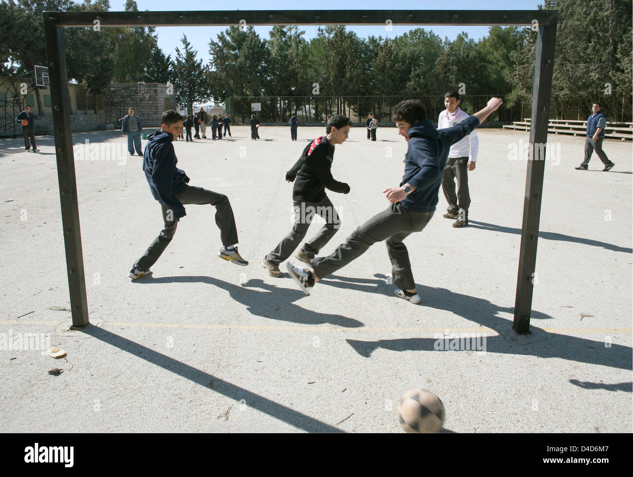 Pupils play soccer on a sports field of the Talitha Kumi school centre ...