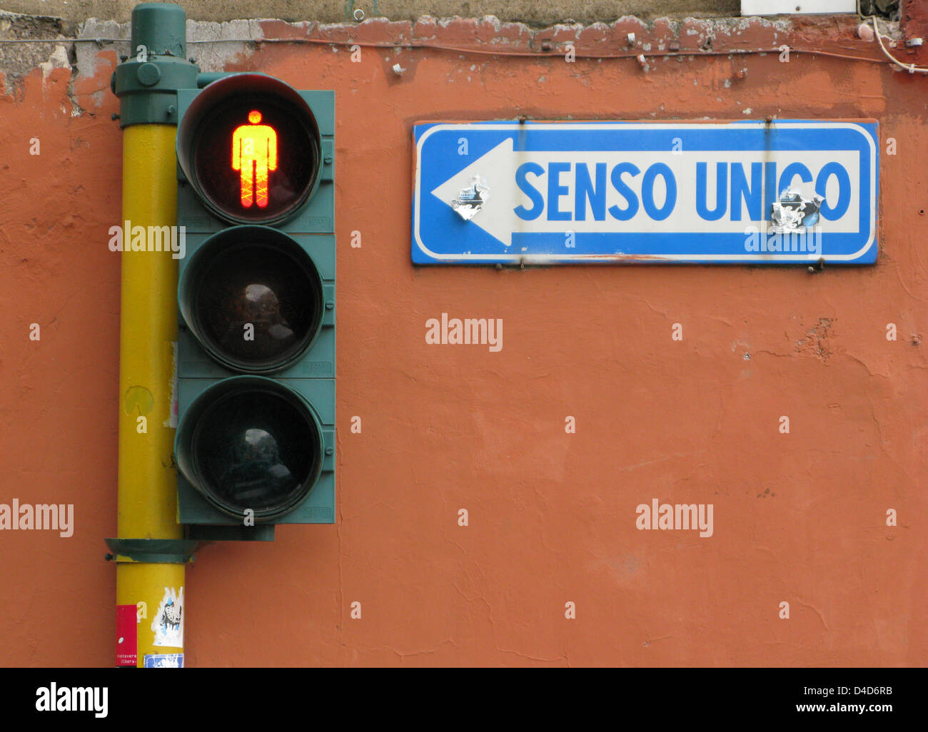 The picture a one-way street sign and a pedestrian traffic light in ...