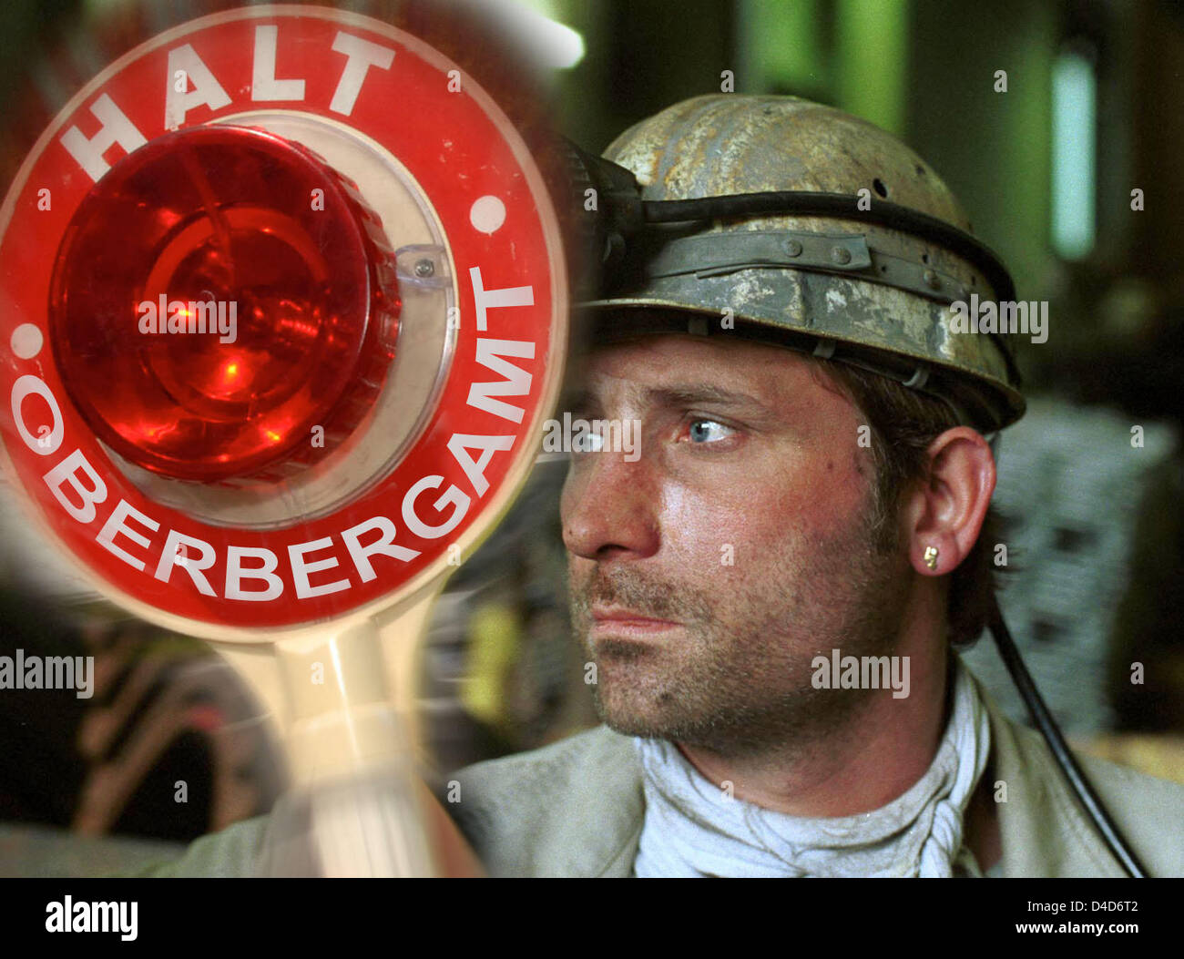 A coal miner holds up a signal disk reading 'Stop, Upper Mining ...