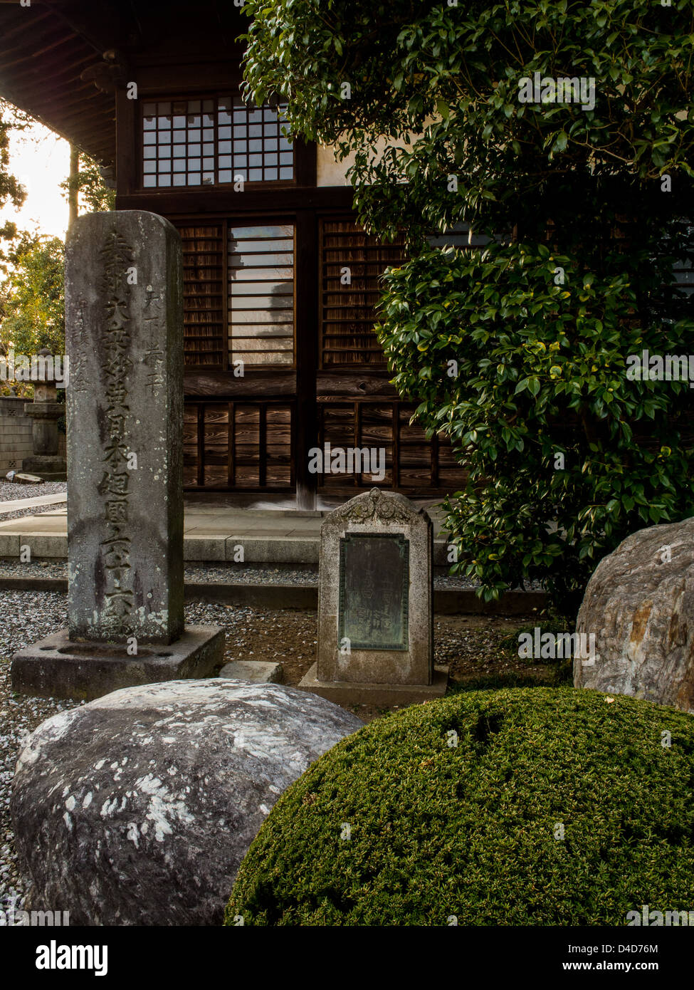A precise and peaceful temple garden featuring natural boulders, stone ...