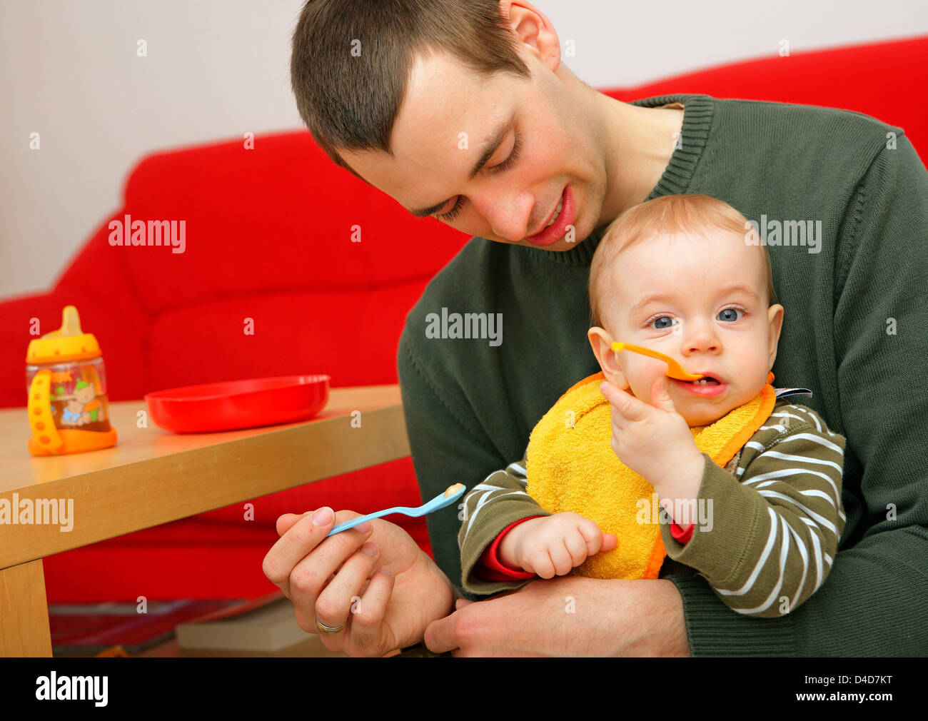 Bjoern Gerth feeds his son Tilman at his home in Mainz, Germany, 20 ...