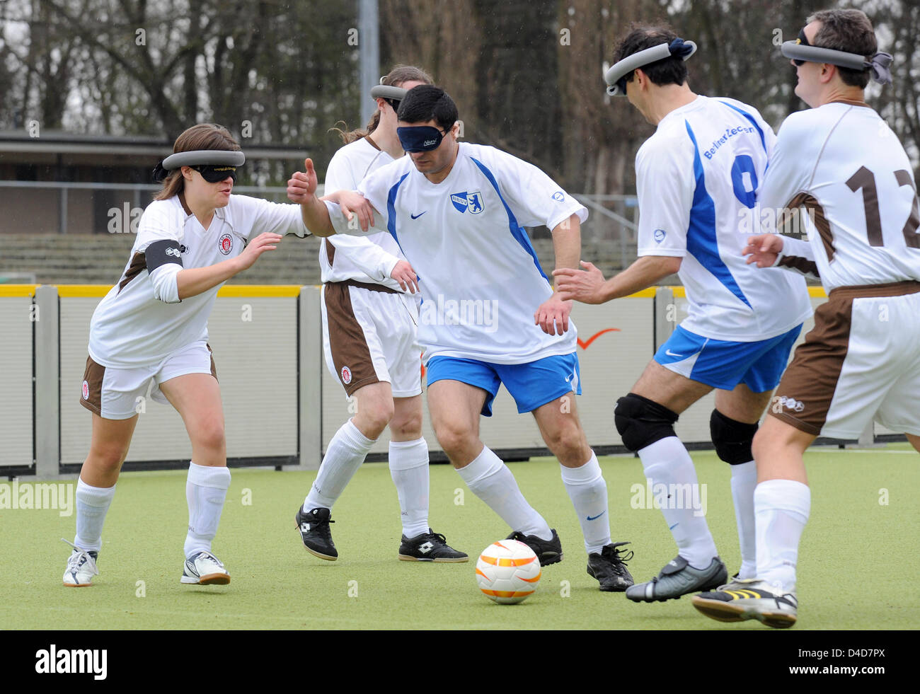 Blind soccer players Markus Baysal (3-R) and Gerd Franzka (2-R) of ...
