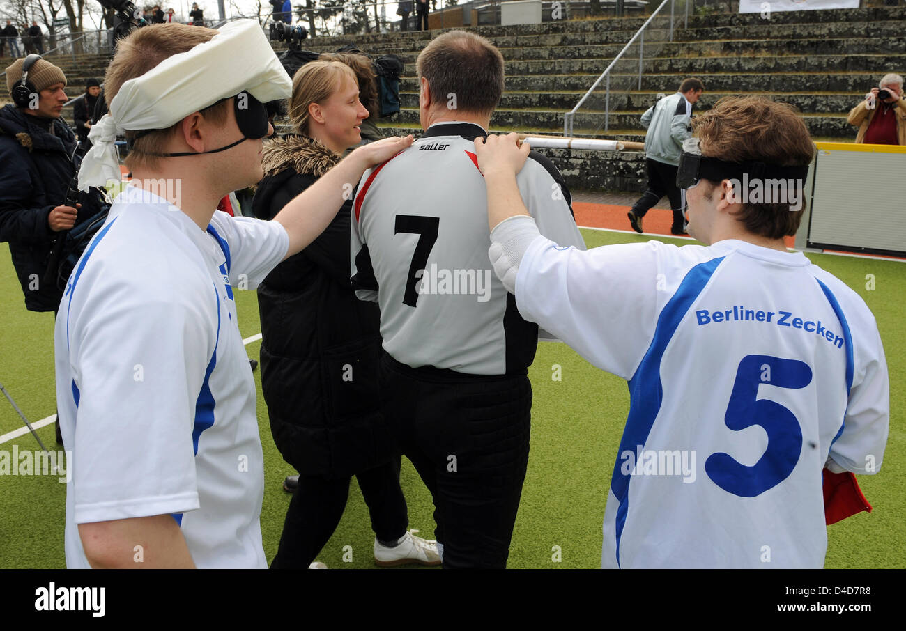 Seeing goalkeeper Ansgar Lopecki (C) leads blind soccer players Ramon ...