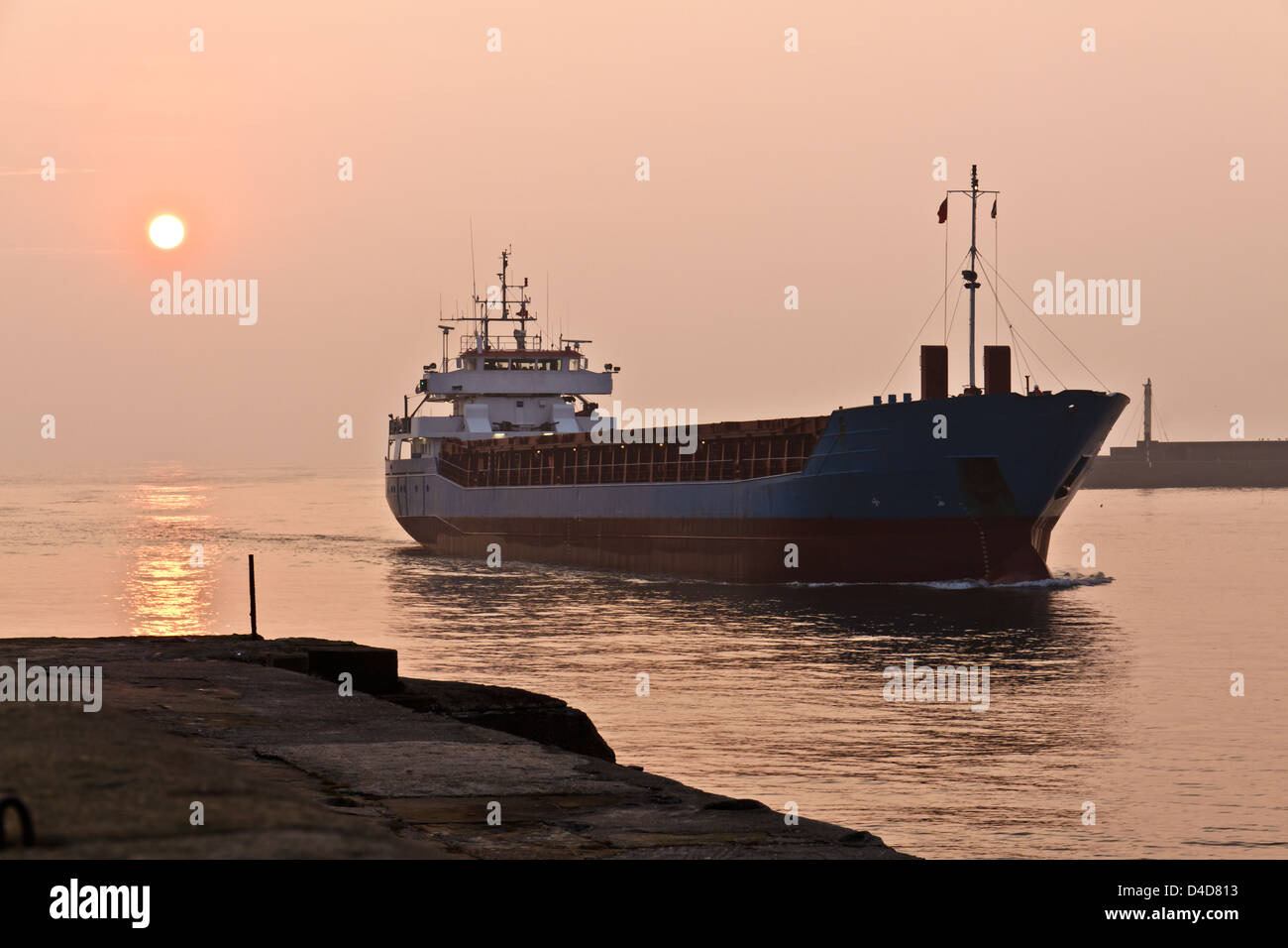 Cargo ship arriving in the morning Stock Photo - Alamy