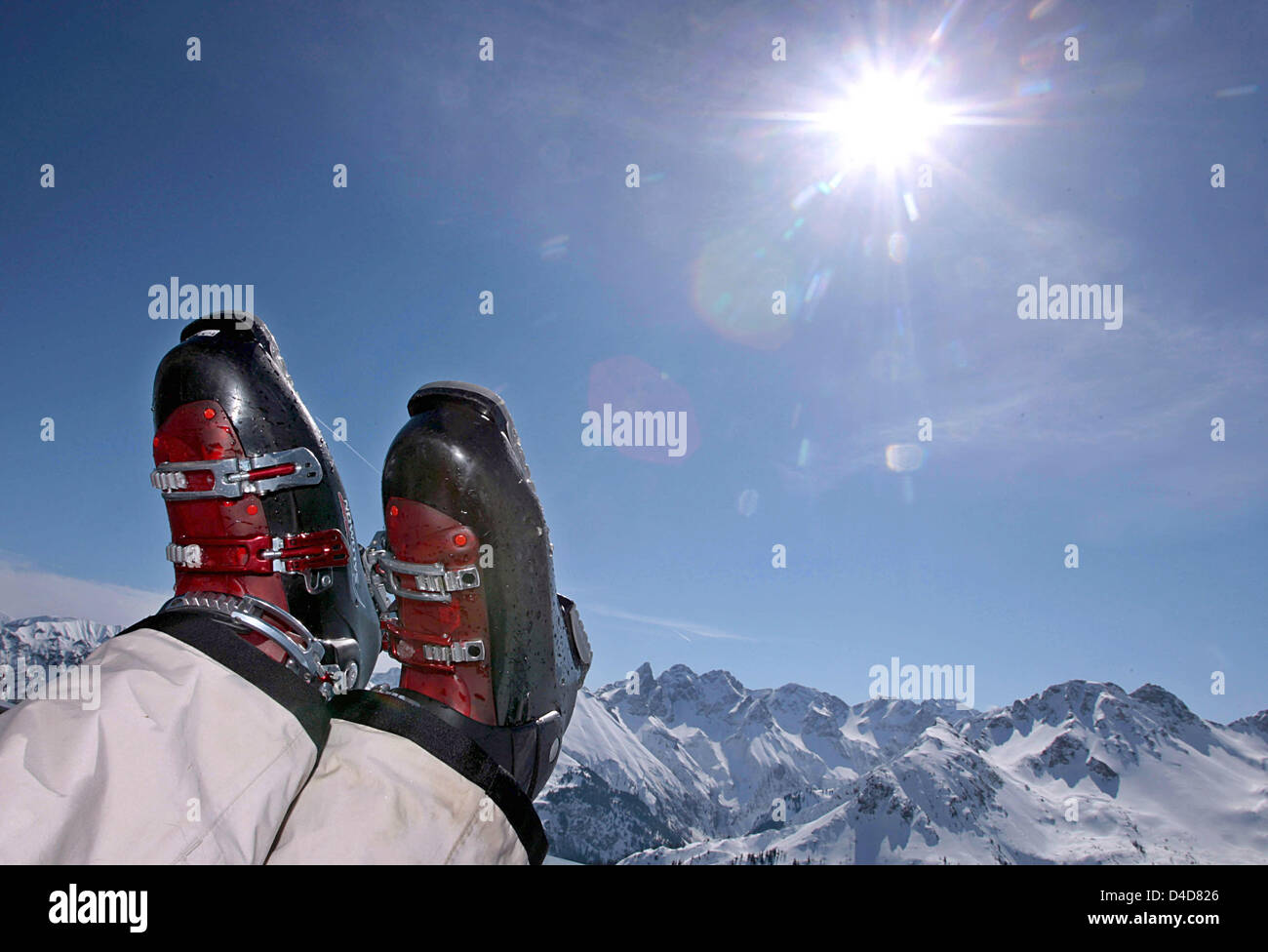 A skiers tans during sunny weather at the Fellhorn mountain near ...