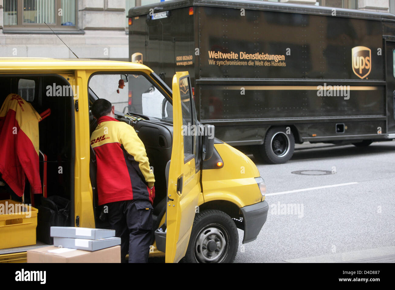 A delivery van of DHL (front) and UPS (back) pictured in downtown ...