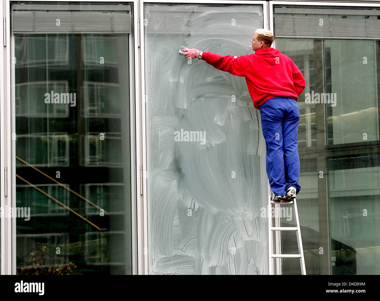A window cleaner cleanses a tower block in Duisburg, Germany, 26 ...