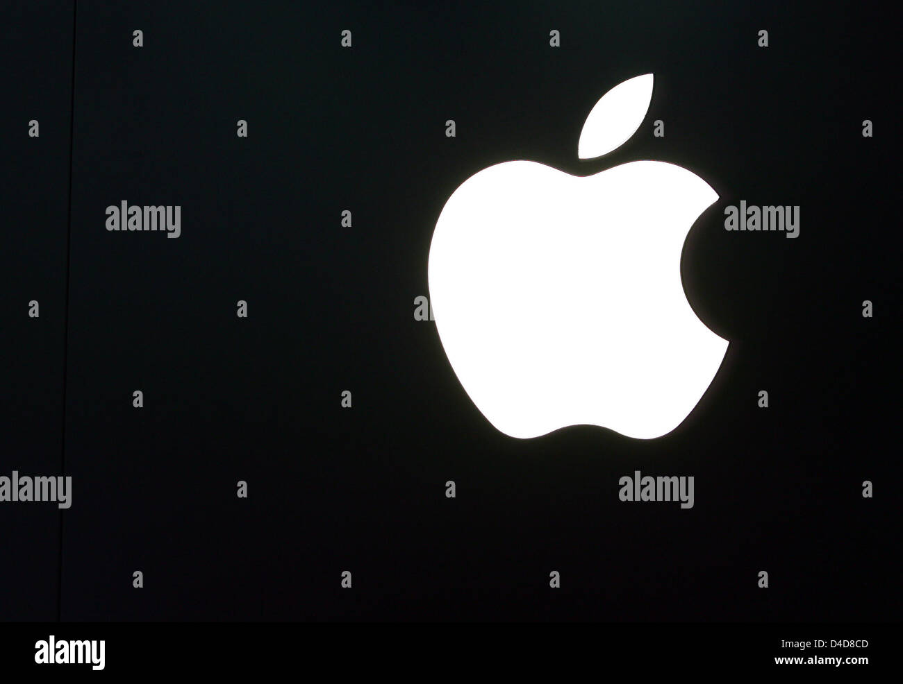 The illuminated logo of the Apple Electronic Company was taken in front ...