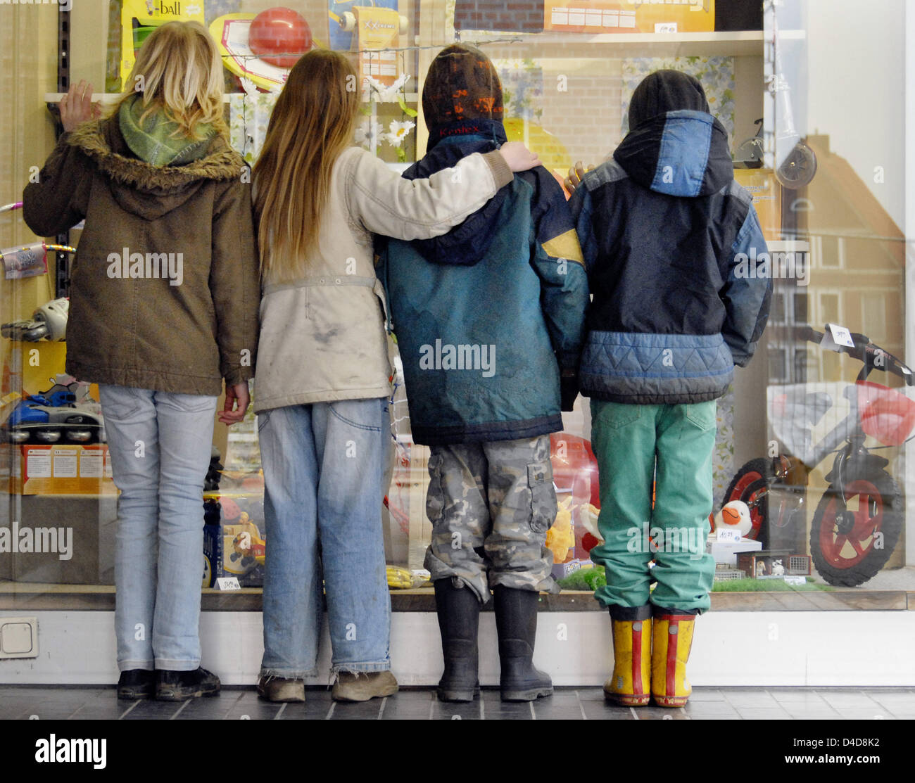 Children look at toys on display in a shop window in Stade, Germany, 24 ...