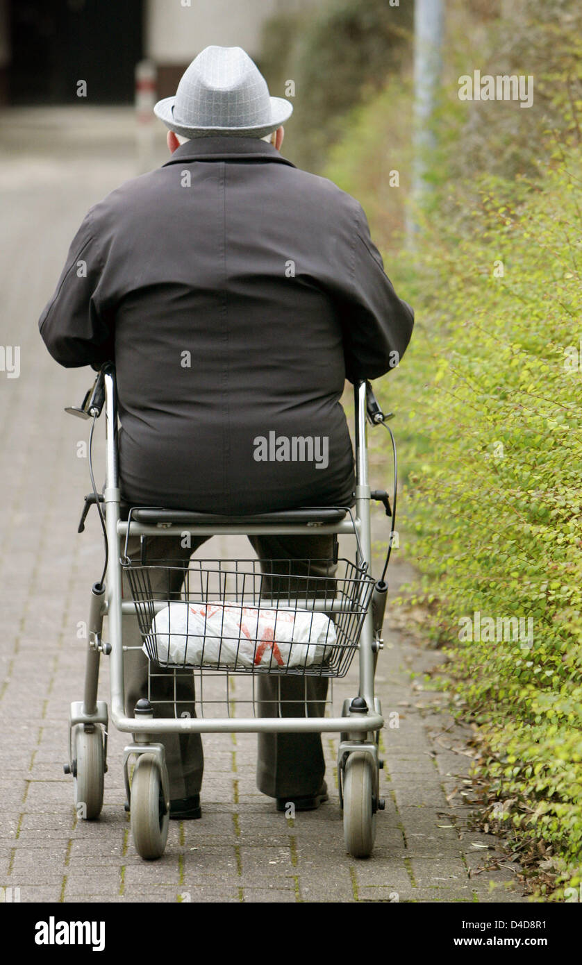 A senior citizen takes a rest on his wheeled walker, a so-called ...