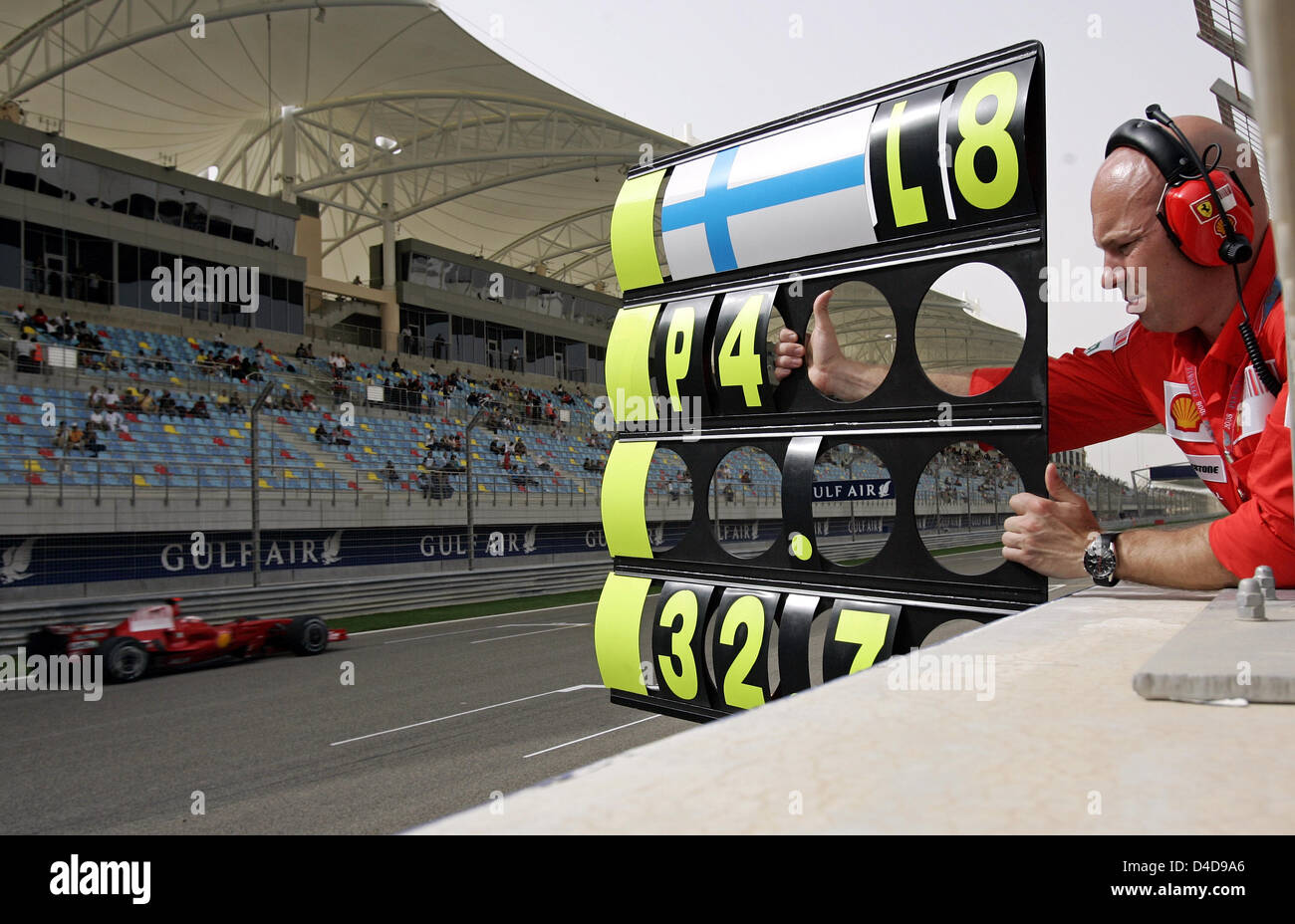 A member of the team holds the pit board while Finnish Formula One ...
