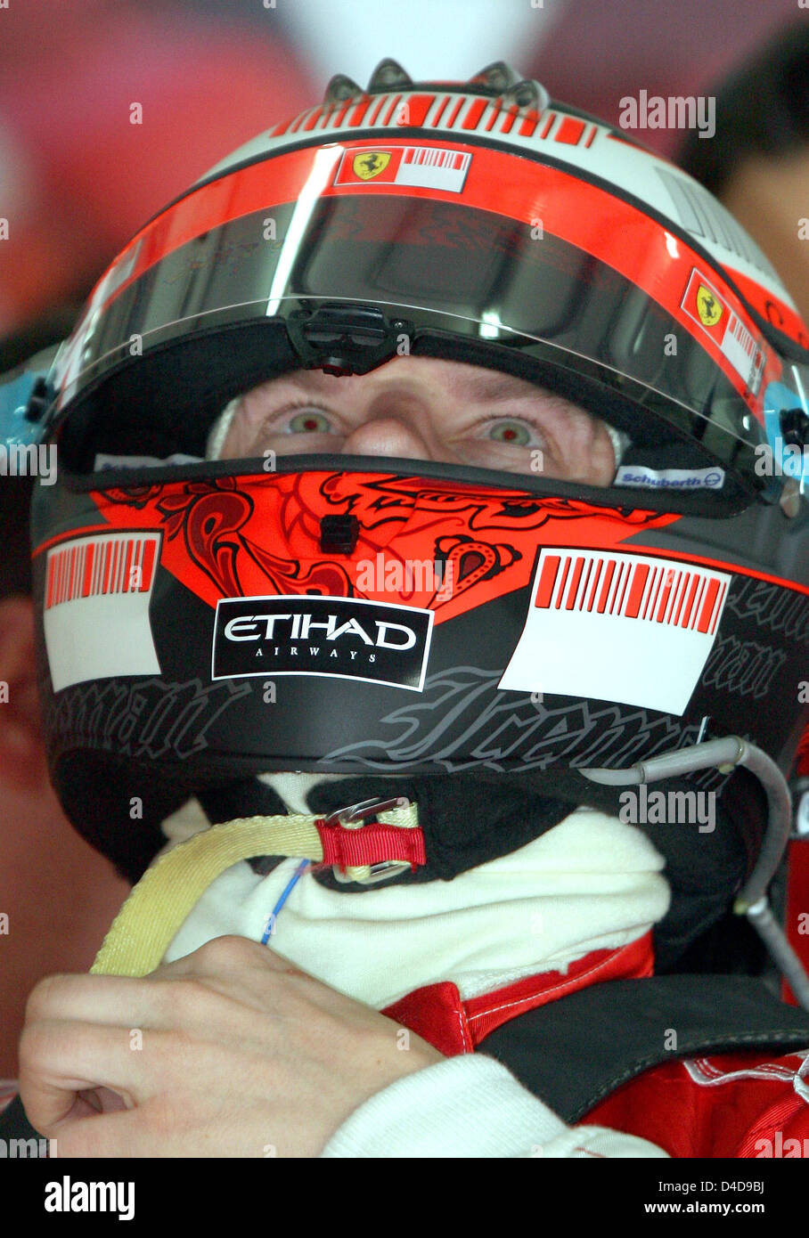 Finnish Formula One driver Kimi Raikkonen of Scuderia Ferrari looks at ...