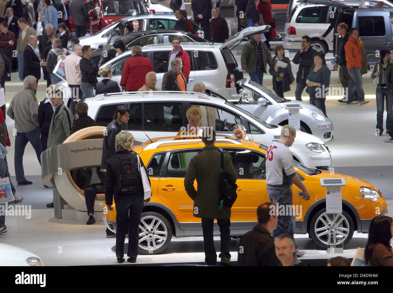 Visitors check out cars at the Auto Mobil International (AMI) motor ...