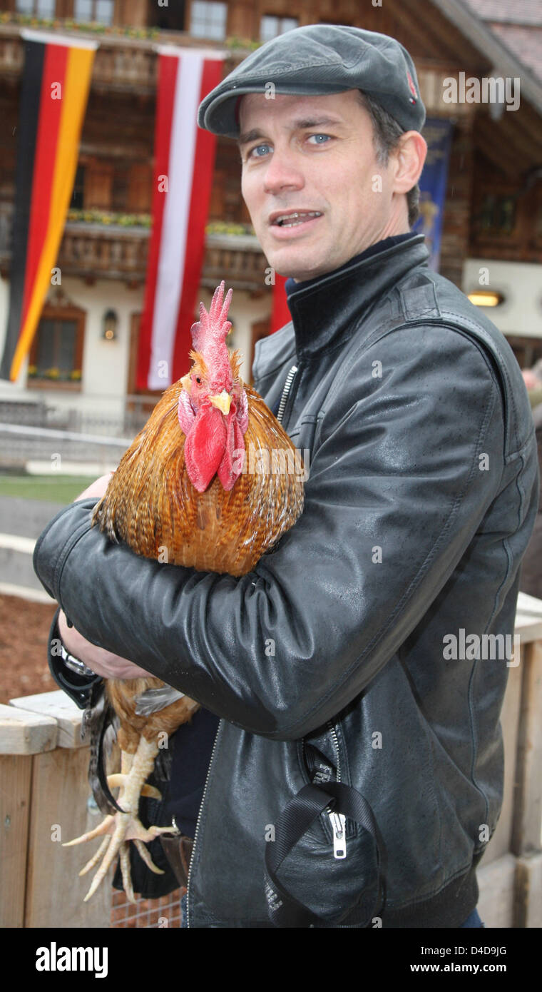 German actor Ralf Bauer poses with a rooster at animal sanctuary Gut ...