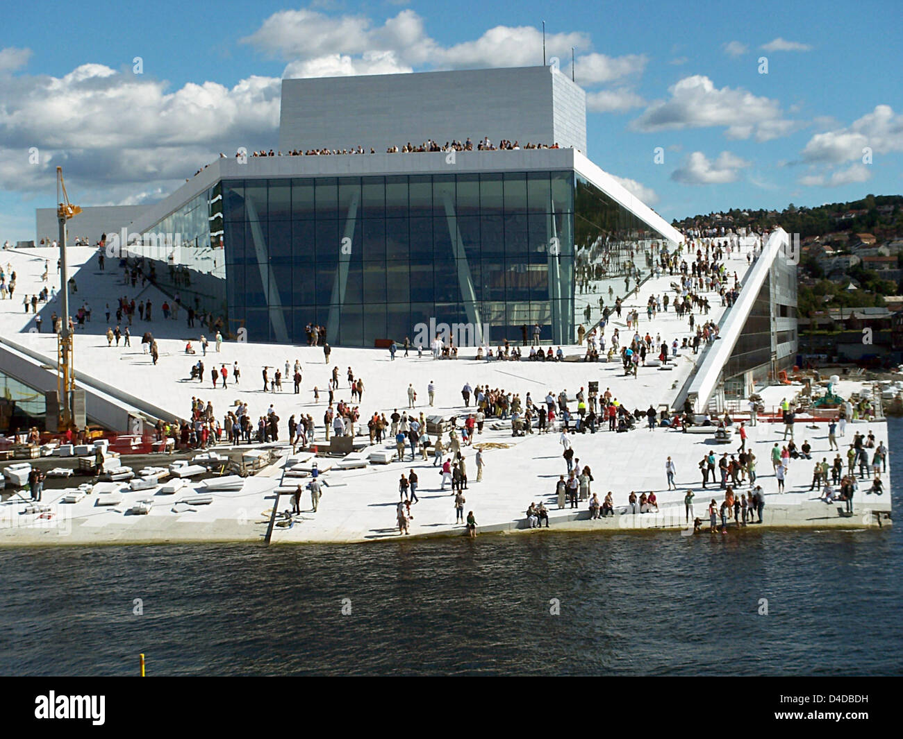People linger around the futuristic new opera of Oslo, Norway, 12 April ...