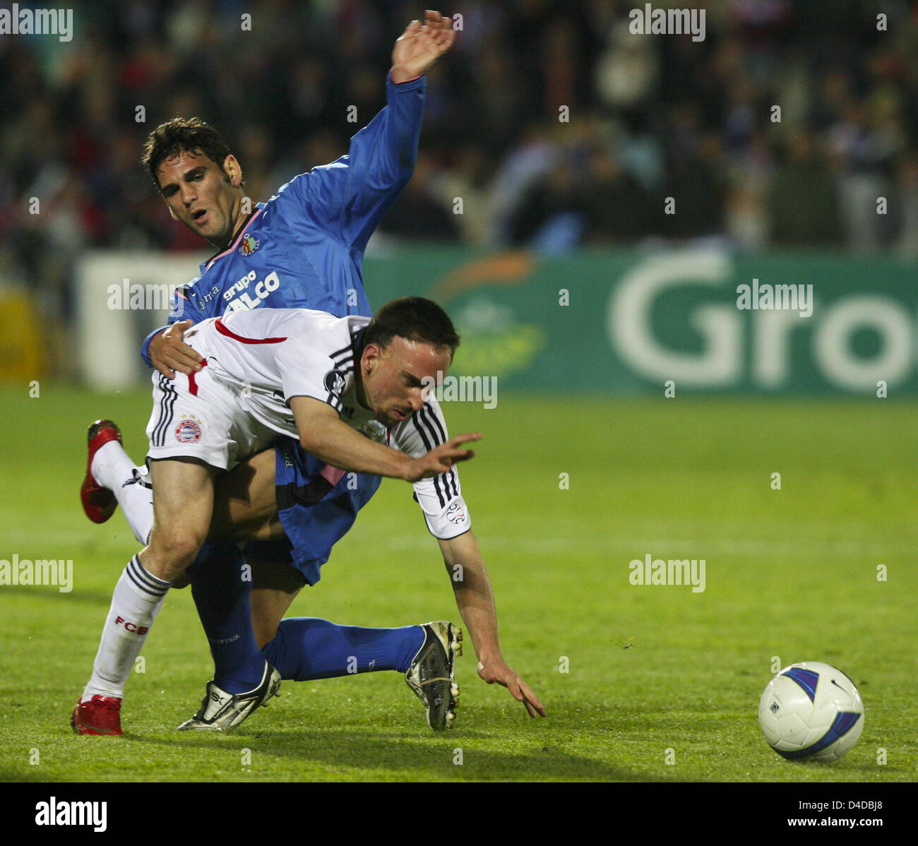 Munich's winger Franck Ribery (front) is wrestled down by Getafe's ...