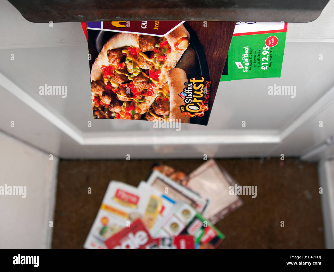 Junk mail and flyers in letterbox, London Stock Photo - Alamy