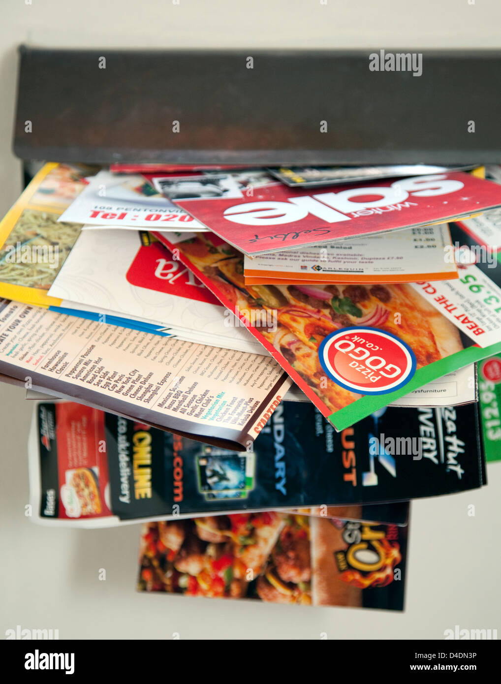 Junk mail and flyers in letterbox, London Stock Photo - Alamy