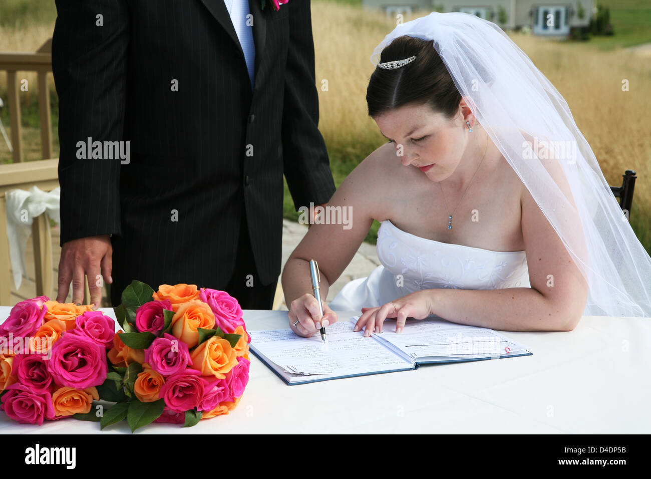 Bride and Groom signing marriage certificate Stock Photo - Alamy