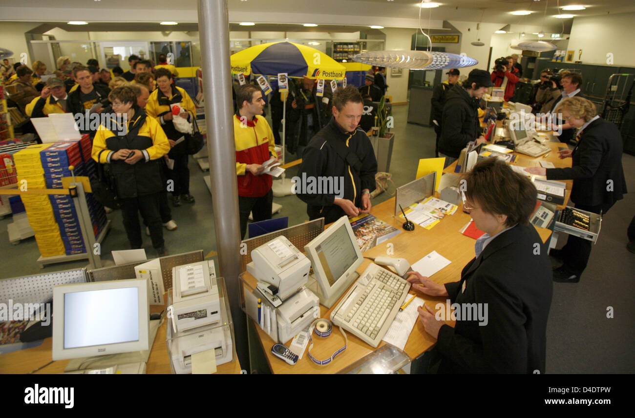 Employees of German postal company Deutsche Post wait in line for at a ...