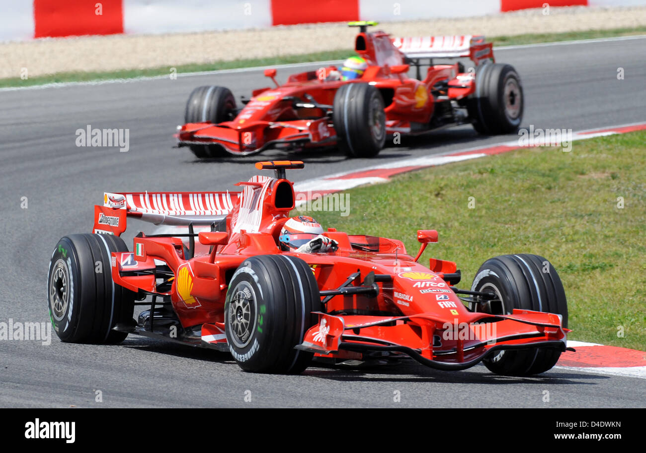 Finnish Formula One driver Kimi Raikkonen (front) of Scuderia Ferrari ...
