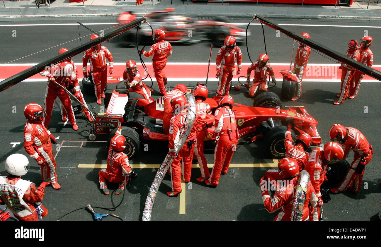 Finnish Formula One driver Kimi Raikkonen (bottom) of Scuderia Ferrari ...