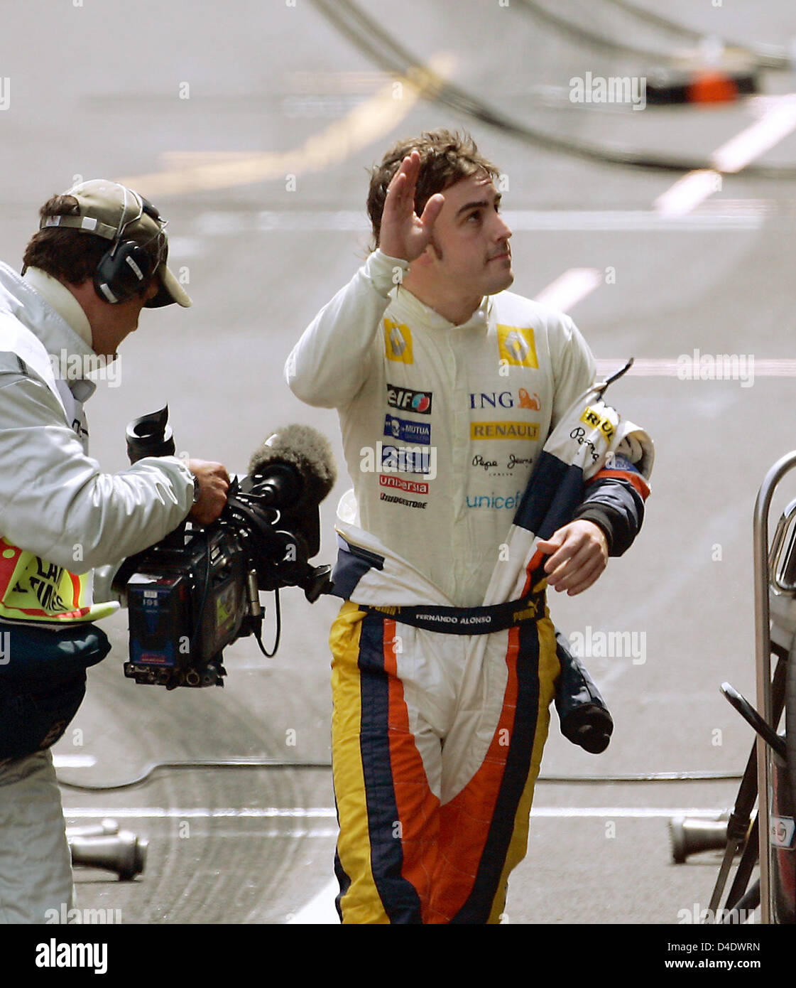 Spanish F1 driver Spanish Fernando Alonso walks through the pitlane ...