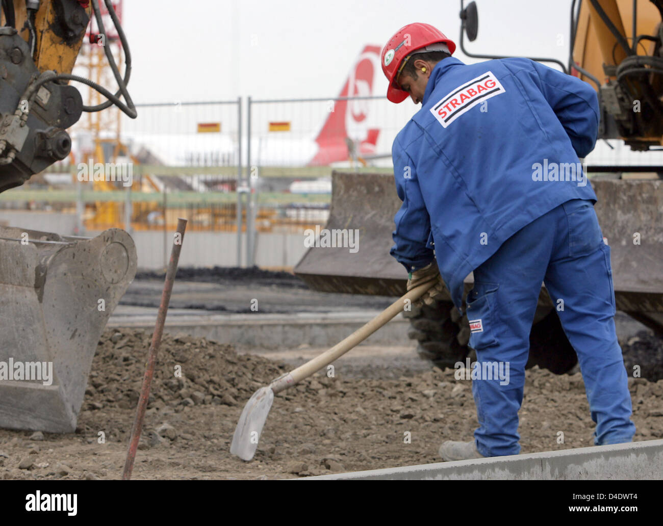 A 'Strabag' worker tarmacs a road in Duesseldorf, Germany, 28 April ...