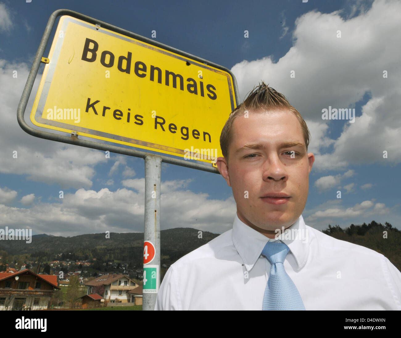 Mayor Michael Adam poses next to the city limits sign of Bodenmais ...