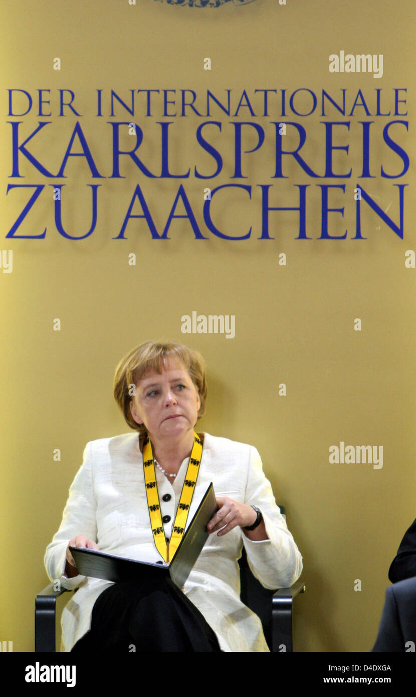 German Chancellor Angela Merkel reads the bestowal document during the ...