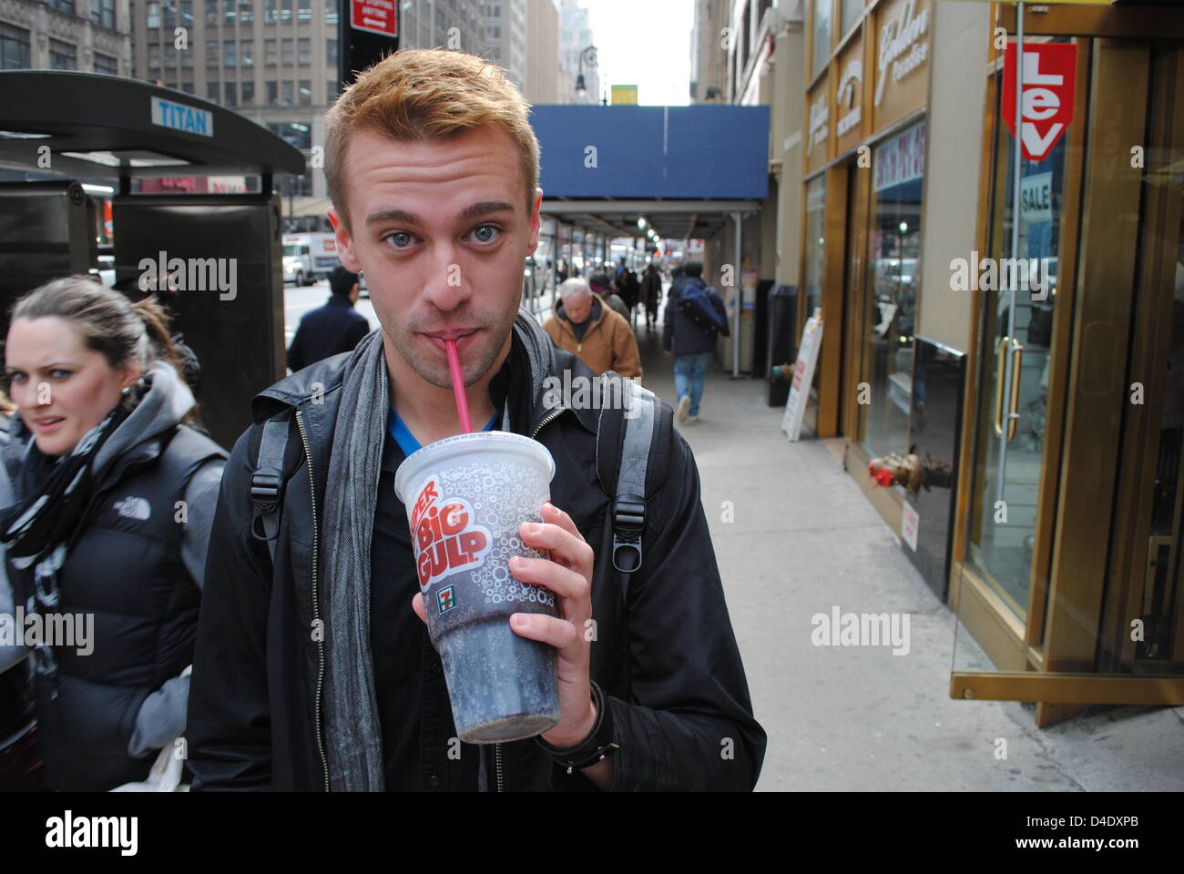 Actress Tylor Brunsmann drinks through a straw out of large cup in New ...