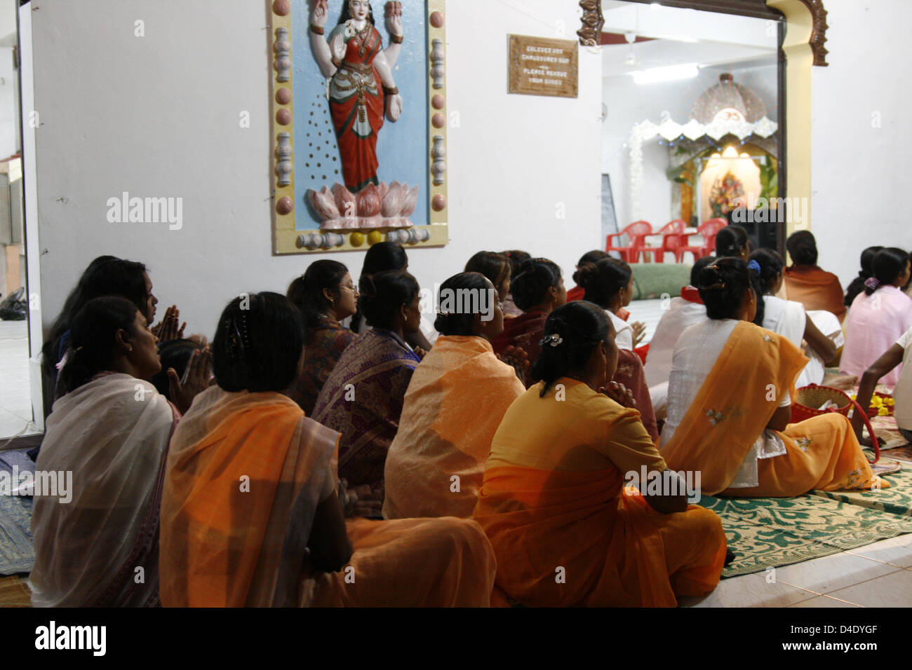 The picture shows Hindu people during their weekly prayer in a Hindu ...