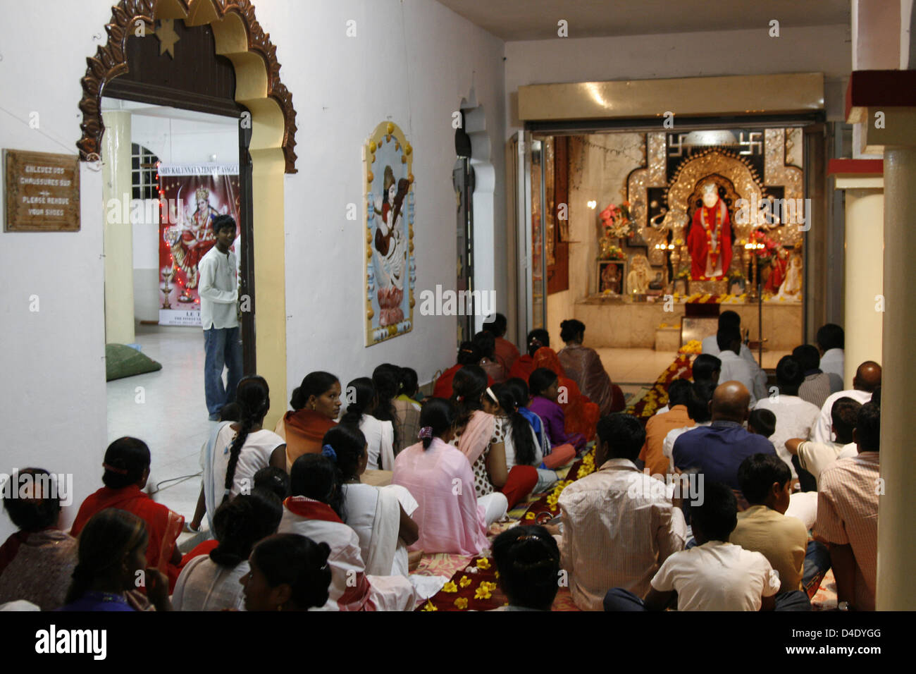 The picture shows Hindu people during their weekly prayer in a Hindu ...