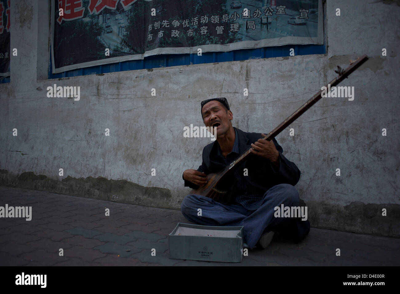 urumchi city homeless playing the guitar Stock Photo - Alamy